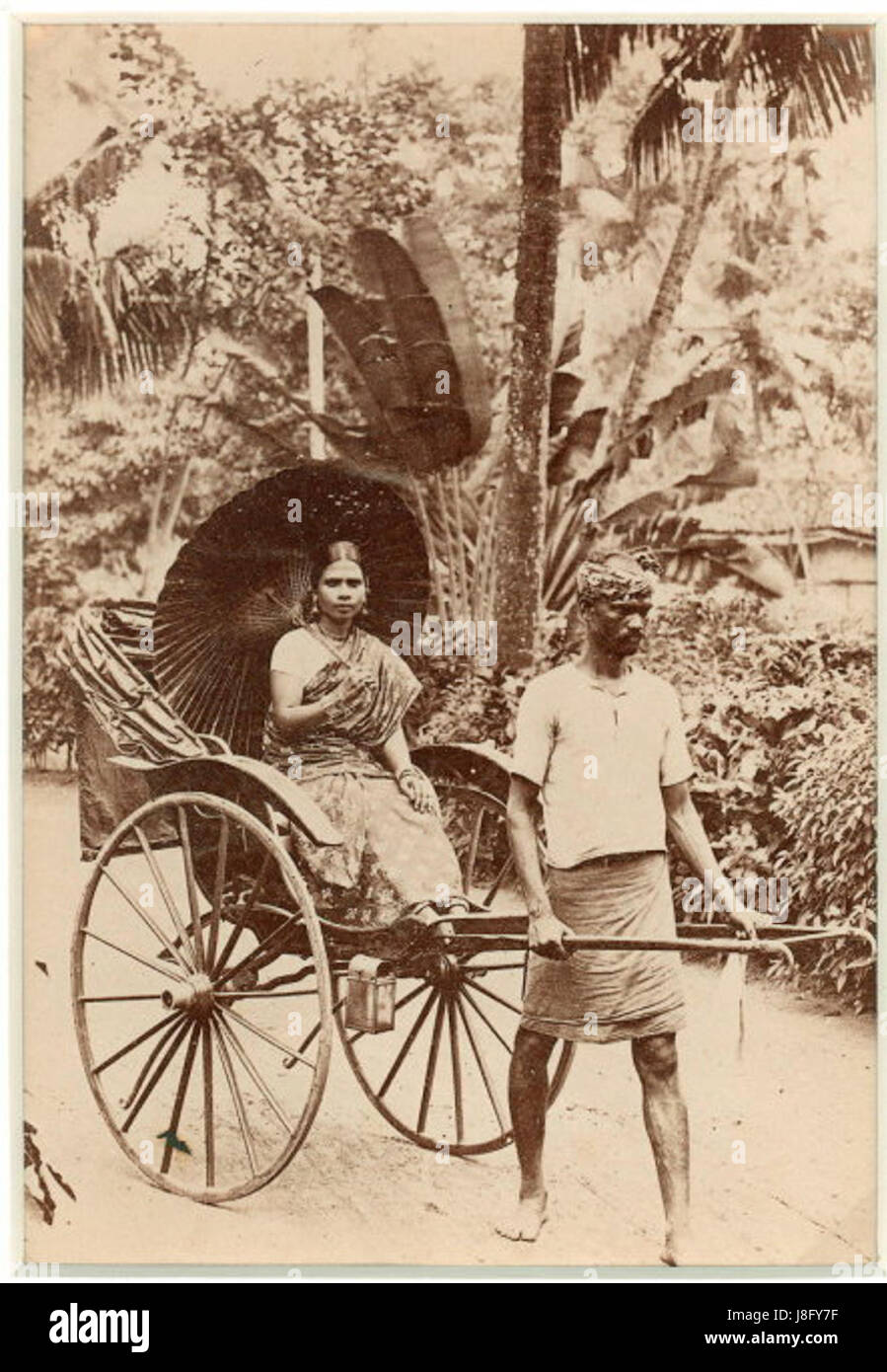 This image depicts a man pulling a lady in a rickshaw, likely from the ...