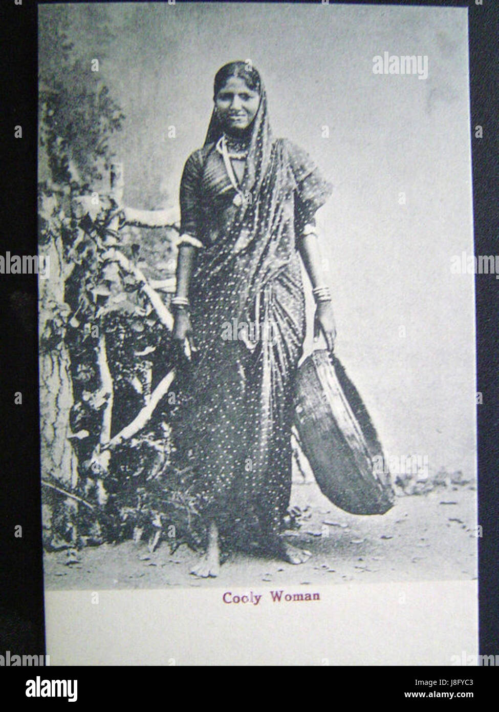 This image depicts an Indian female coolie (laborer) from around 1910 ...