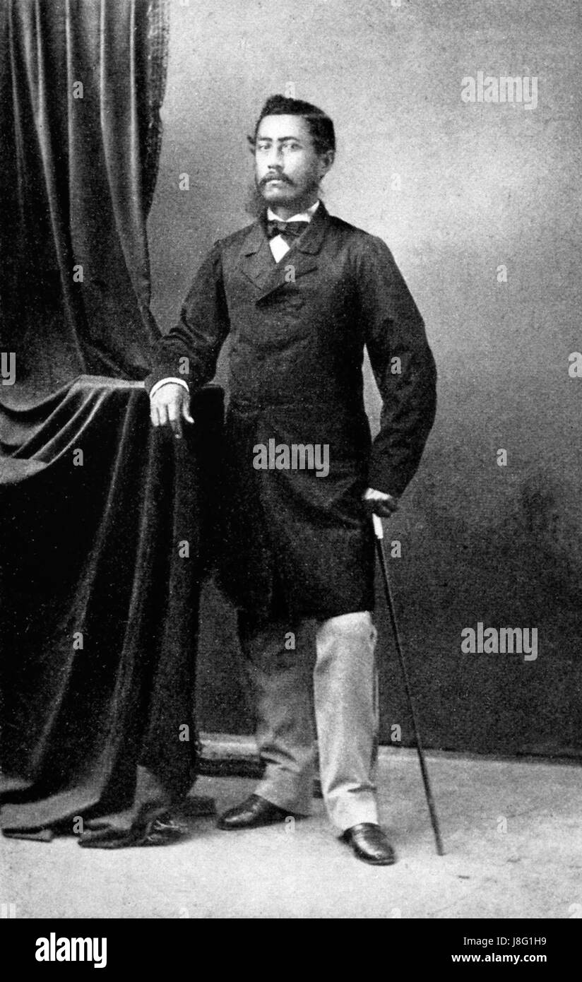 A photograph of King Lunalilo of Hawaii standing with a cane, taken by ...