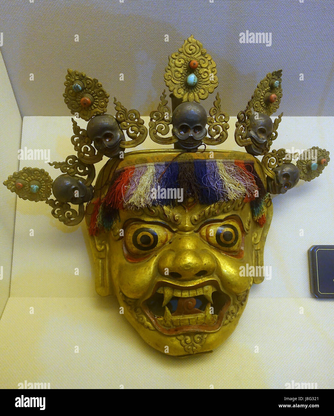 This Tibetan mask, dating from 1644 to 1911, is crafted from gilt ...