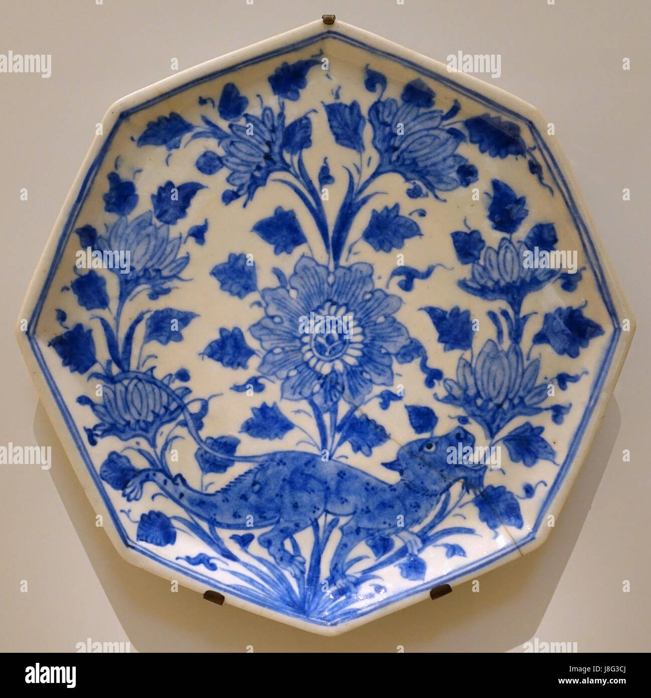 A 17th-century Iranian dish featuring a wolf among floral blossoms ...