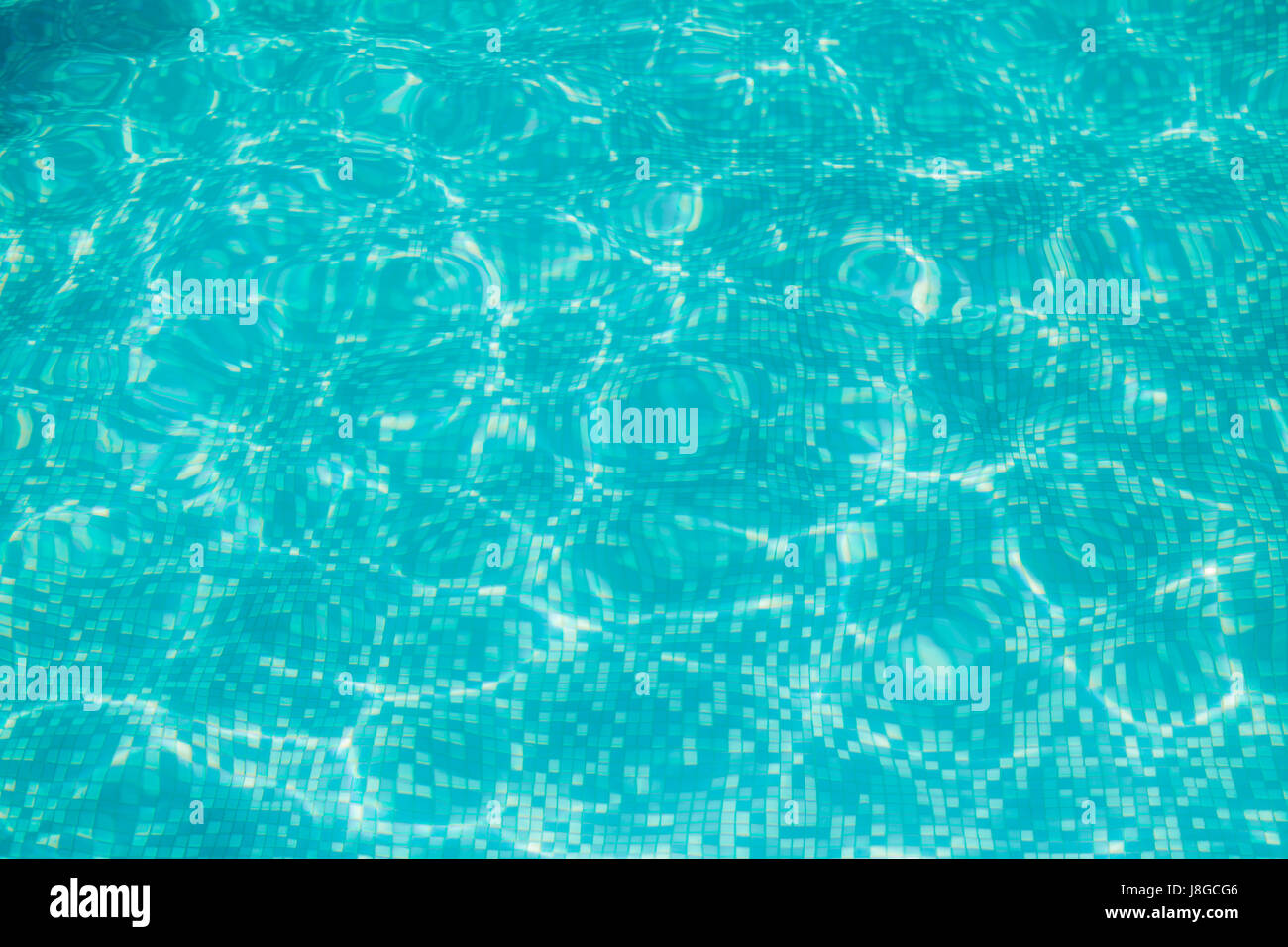 Blue pool water with sun reflections summer mood Stock Photo - Alamy
