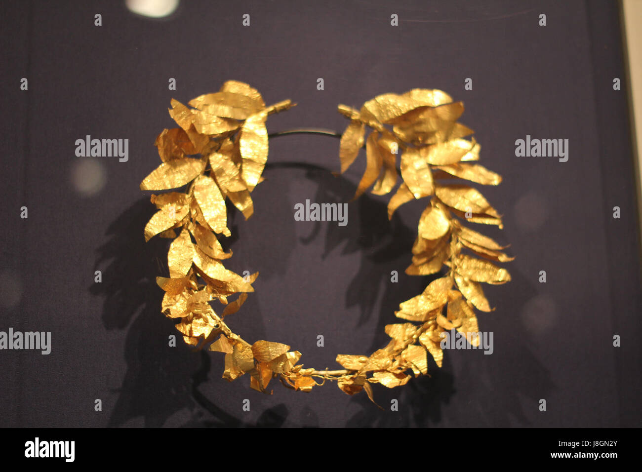 A gold wreath, often used in ancient cultures as a symbol of honor or ...