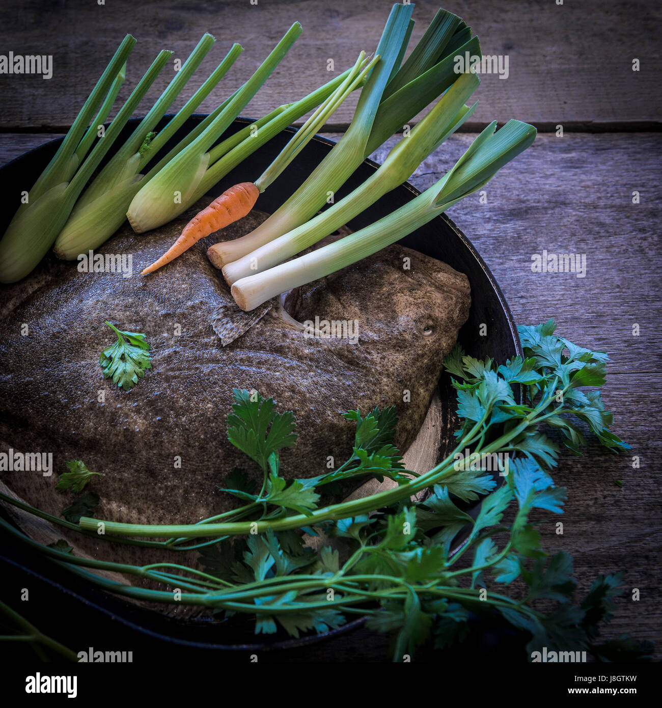 A turbot surrounded by baby vegetables; Food; Fish; Seafood; Flatfish ...