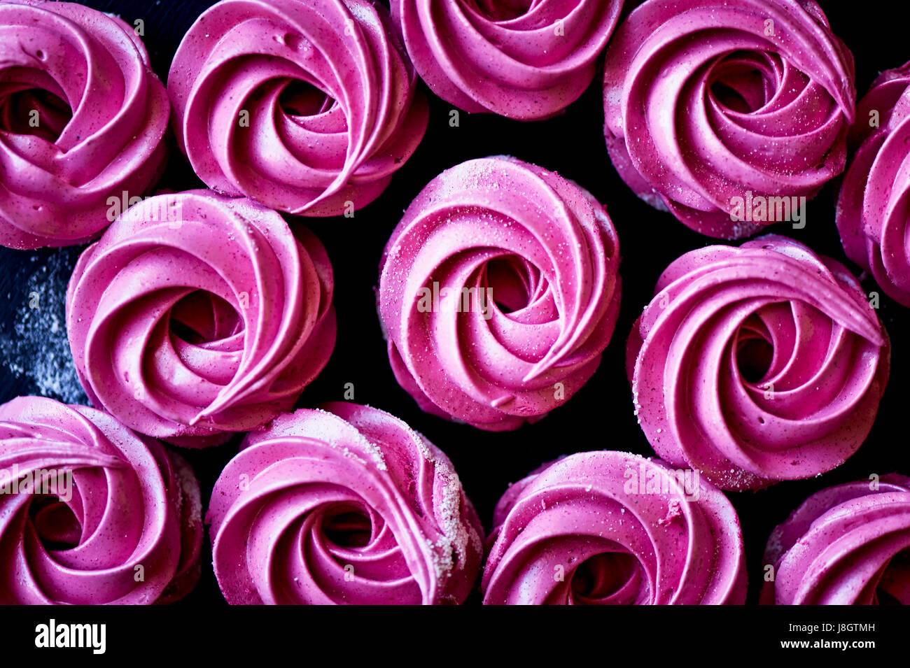 Many purple marshmallow on a dark surface. A contrasting picture.A work ...