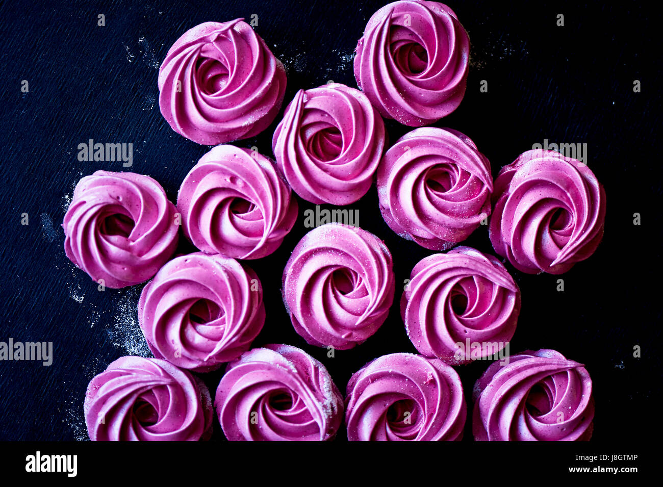 Many purple marshmallow on a dark surface. A contrasting picture.A work ...