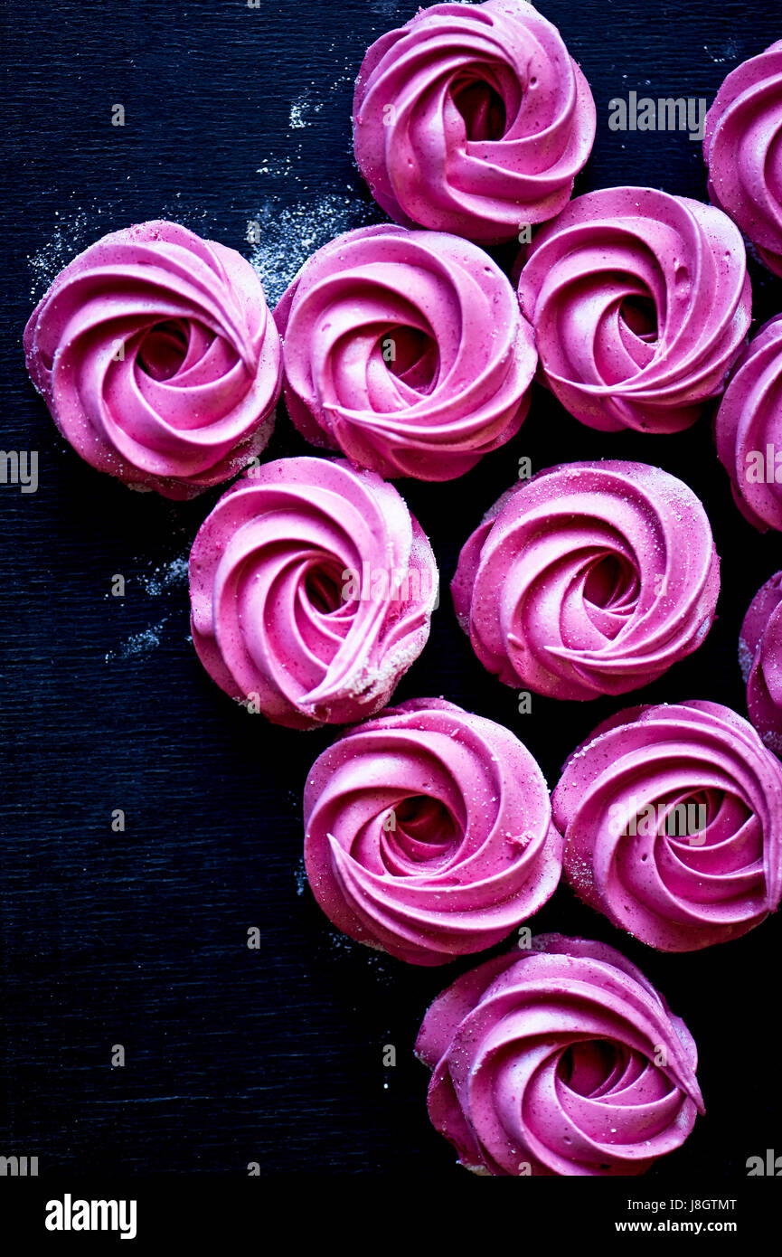 Many purple marshmallow on a dark surface. A contrasting picture.A work ...