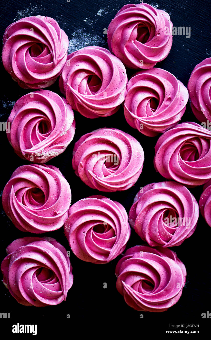 Many purple marshmallow on a dark surface. A contrasting picture.A work ...