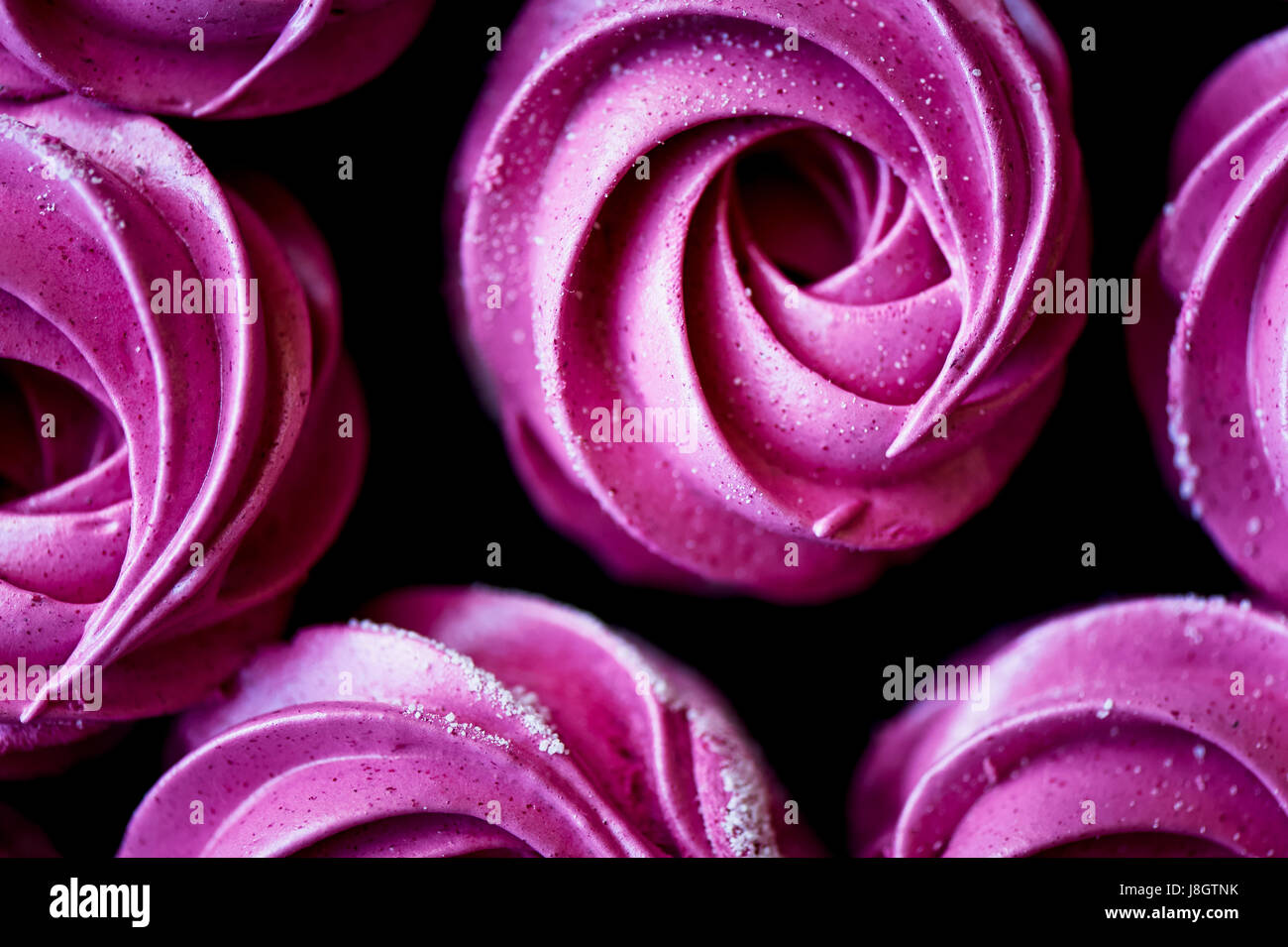 Many purple marshmallow on a dark surface. A contrasting picture.A work ...