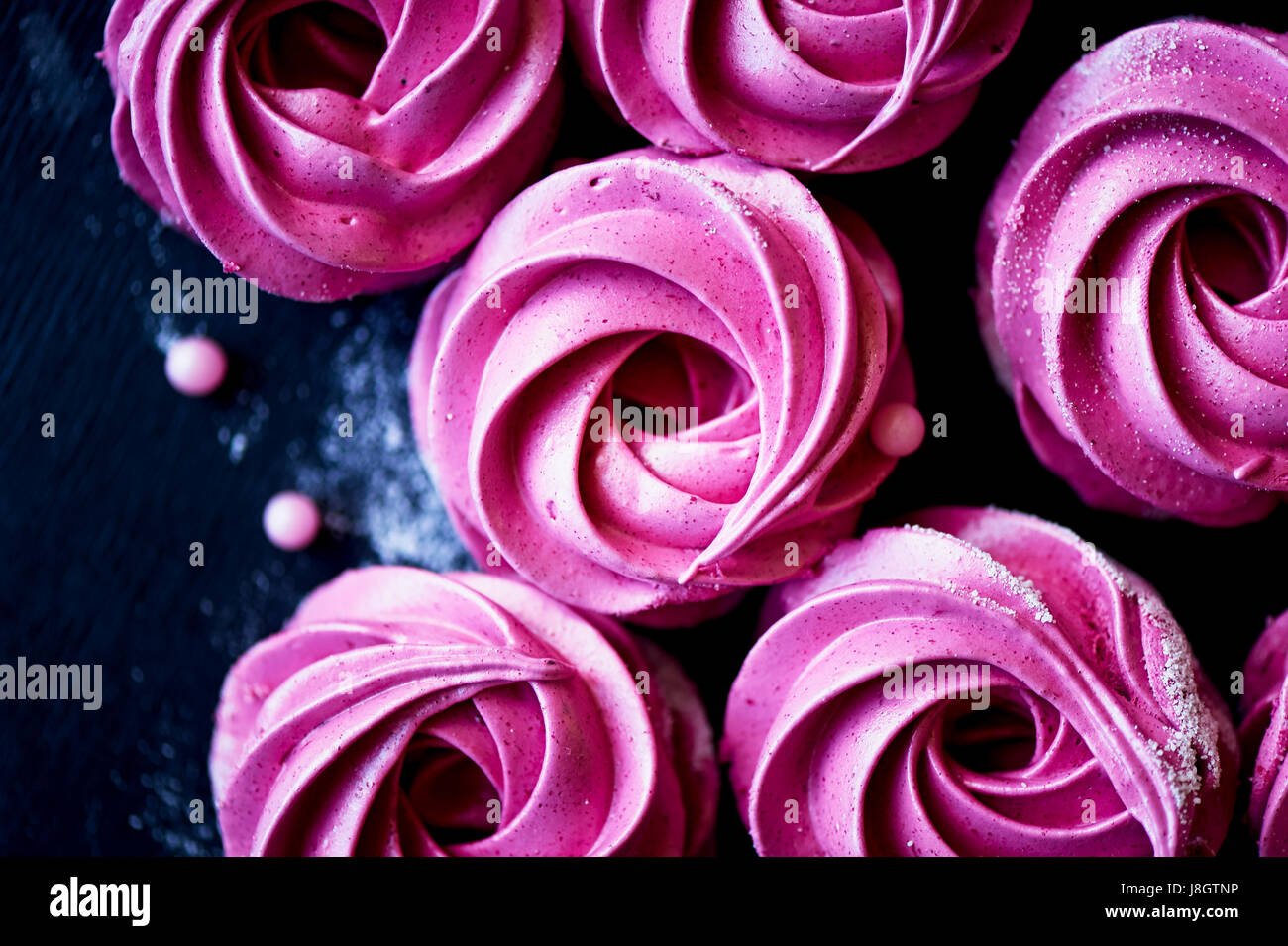 Many purple marshmallow on a dark surface. A contrasting picture.A work ...