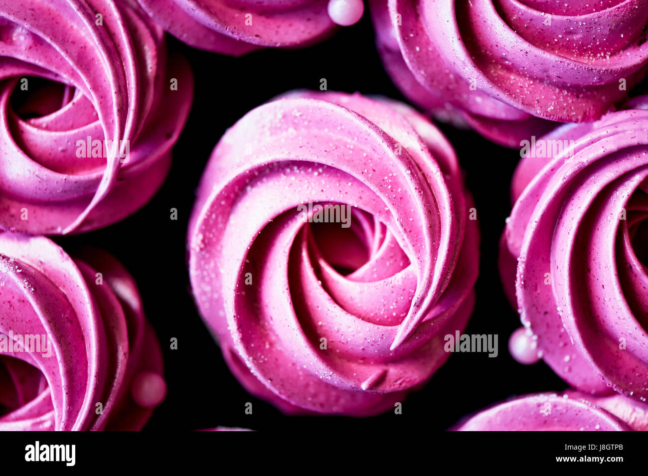 Many purple marshmallow on a dark surface. A contrasting picture.A work ...