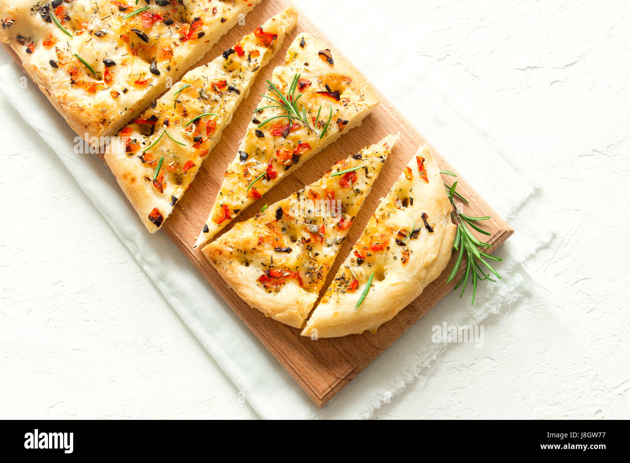 Traditional Italian Focaccia with tomatoes, black olives and rosemary ...