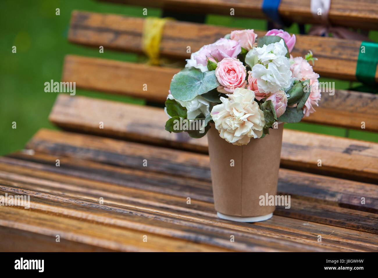 Small bouquet of flowers on a wooden bench Stock Photo - Alamy