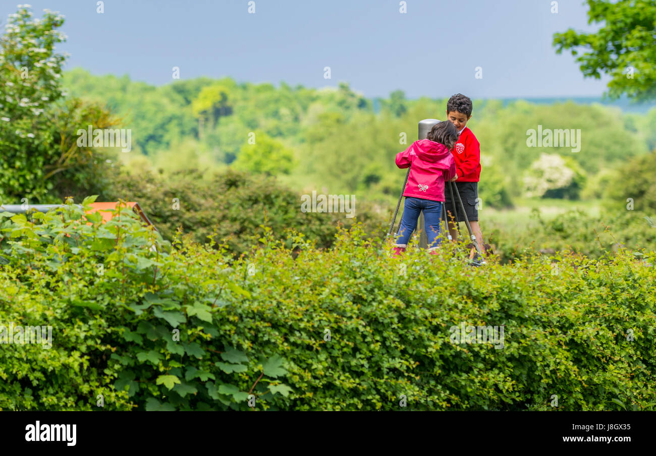 Children playing on top of playground apparatus in a small countryside ...