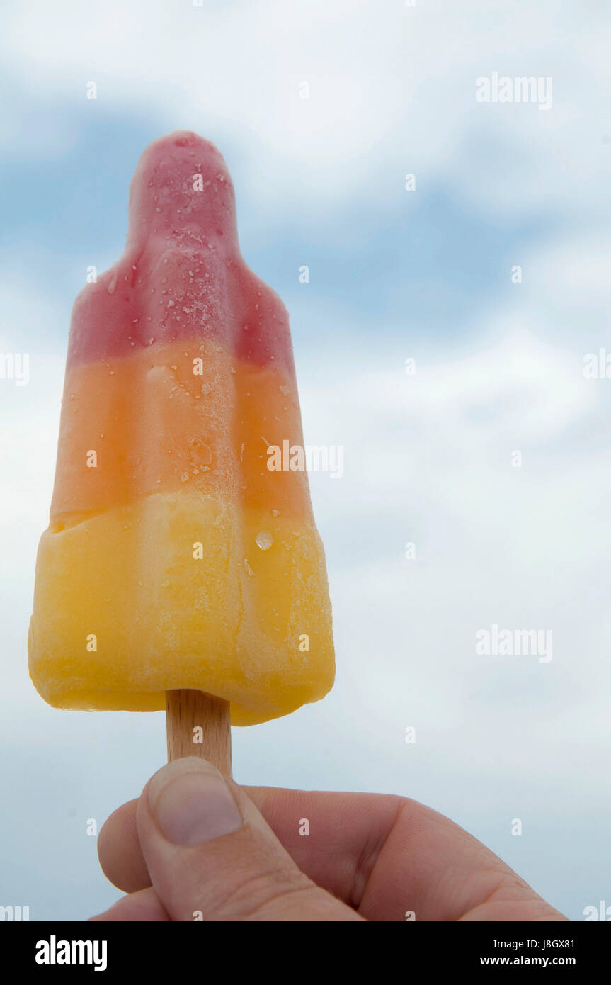 Person holding a colorful popsicle 'raketje' in hand Stock Photo - Alamy