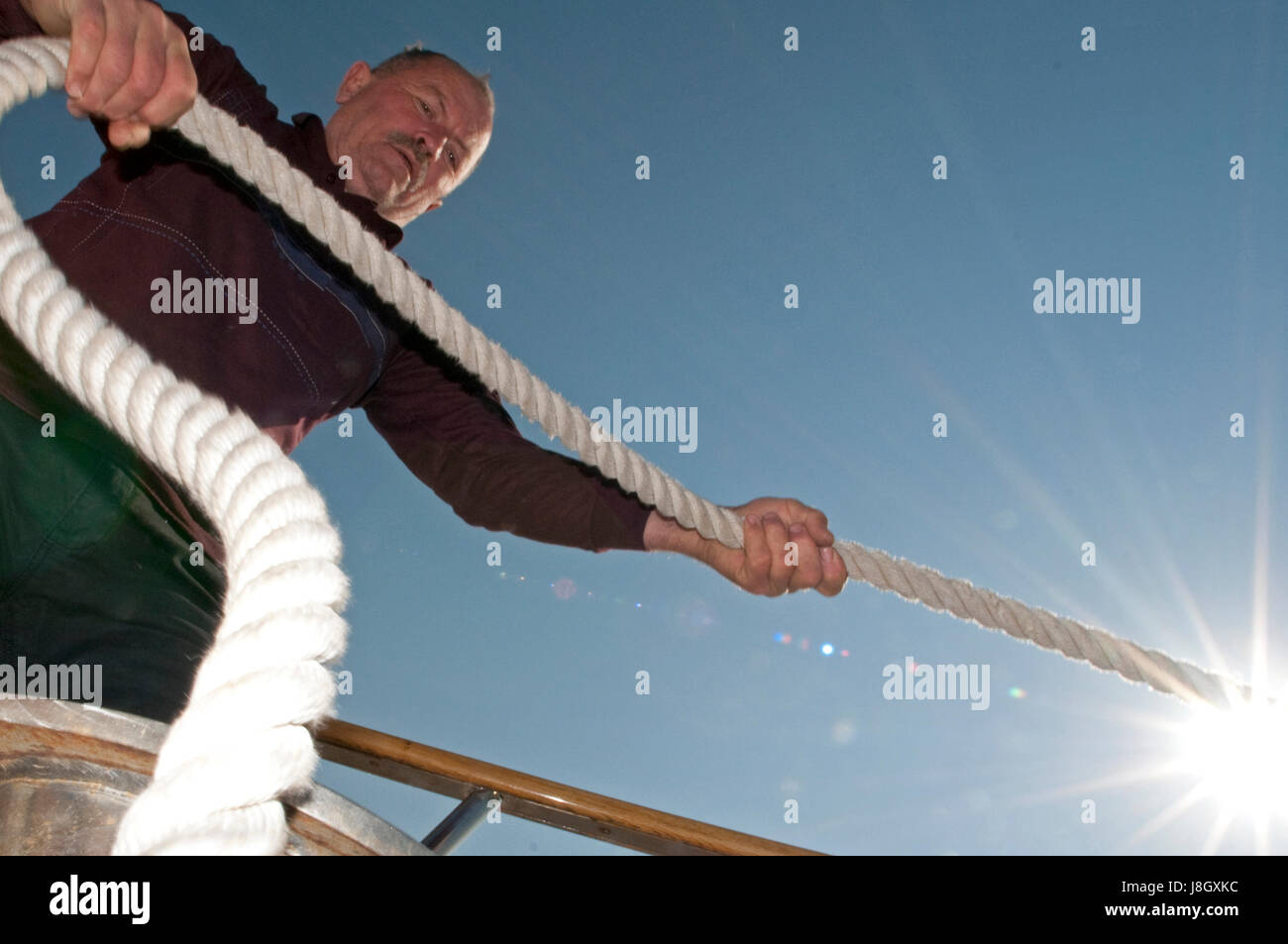 A sailor docking his boat in the harbour in Croatia Stock Photo - Alamy