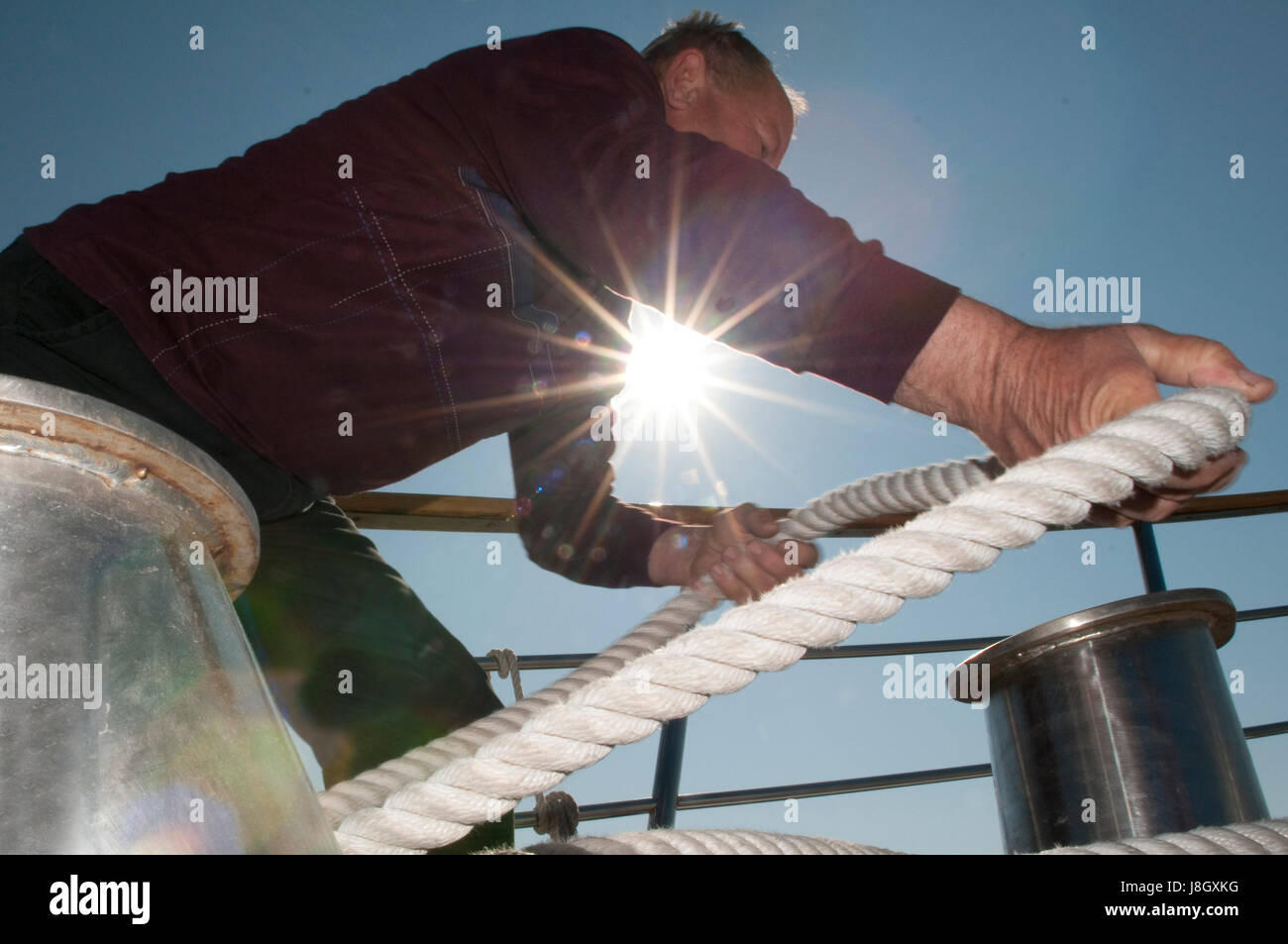 A sailor docking his boat in the harbour in Croatia Stock Photo - Alamy