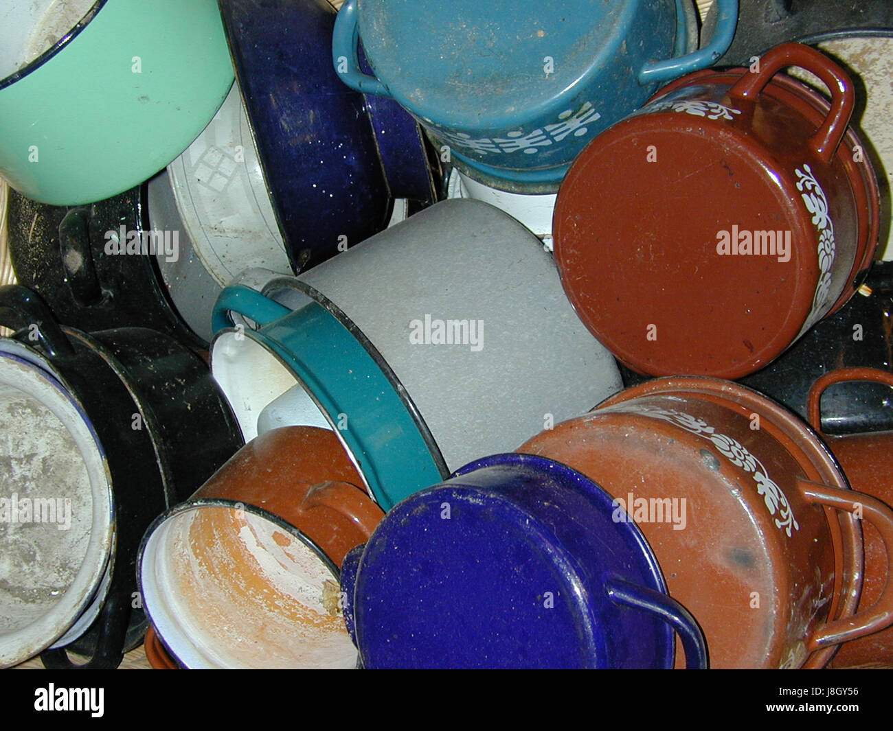 A messy collection of old rustic pots and pans Stock Photo - Alamy