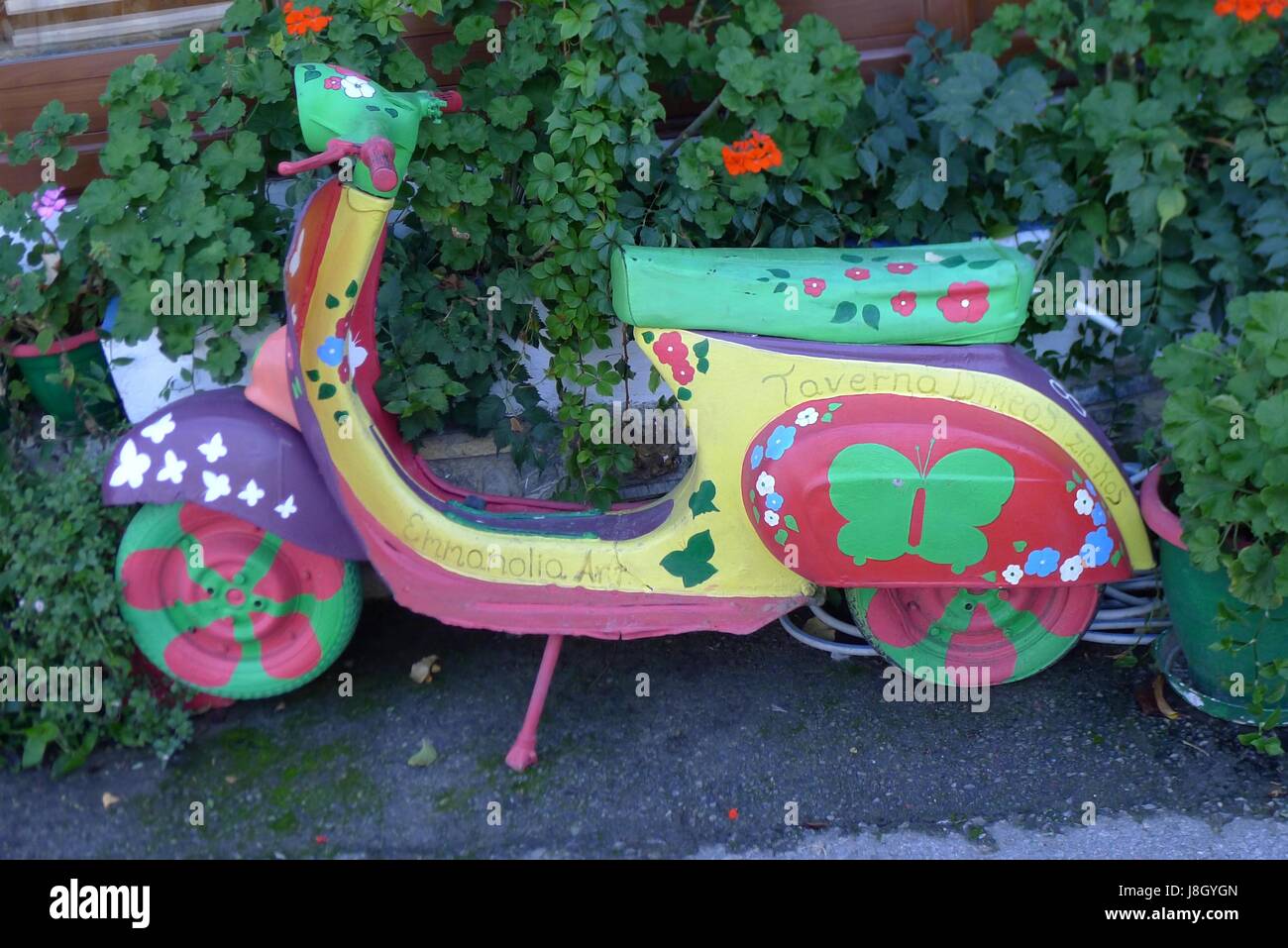 An artistically decorated scooter in front of a tavern makes a ...