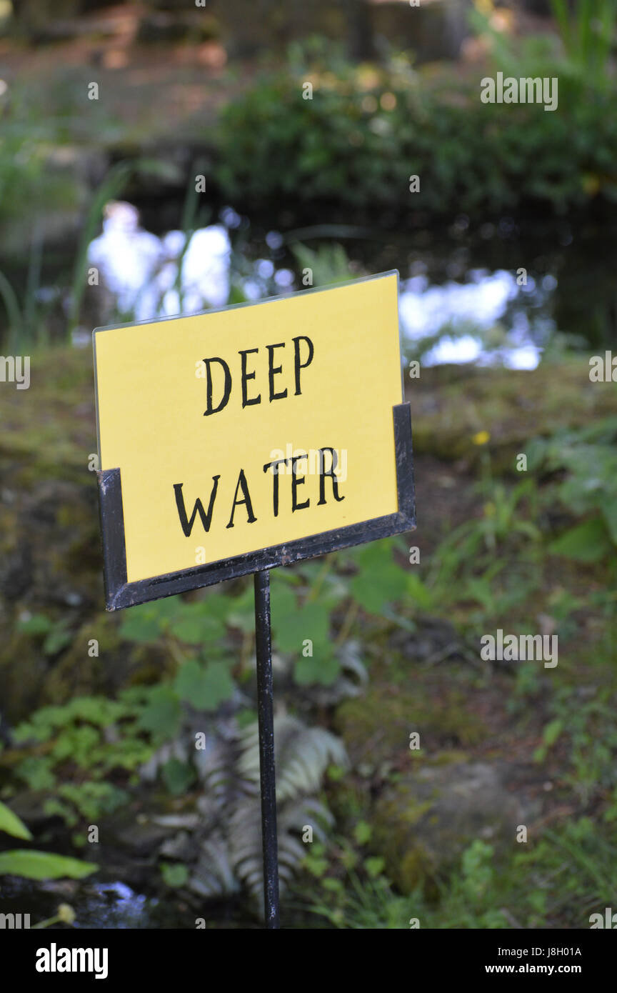Deep water warning sign beside waters edge Stock Photo - Alamy