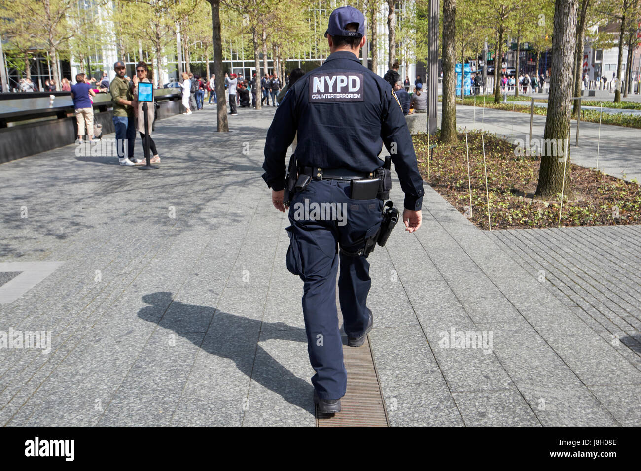 nypd counterterrorism officer walking through the 9/11 memorial plaza ...