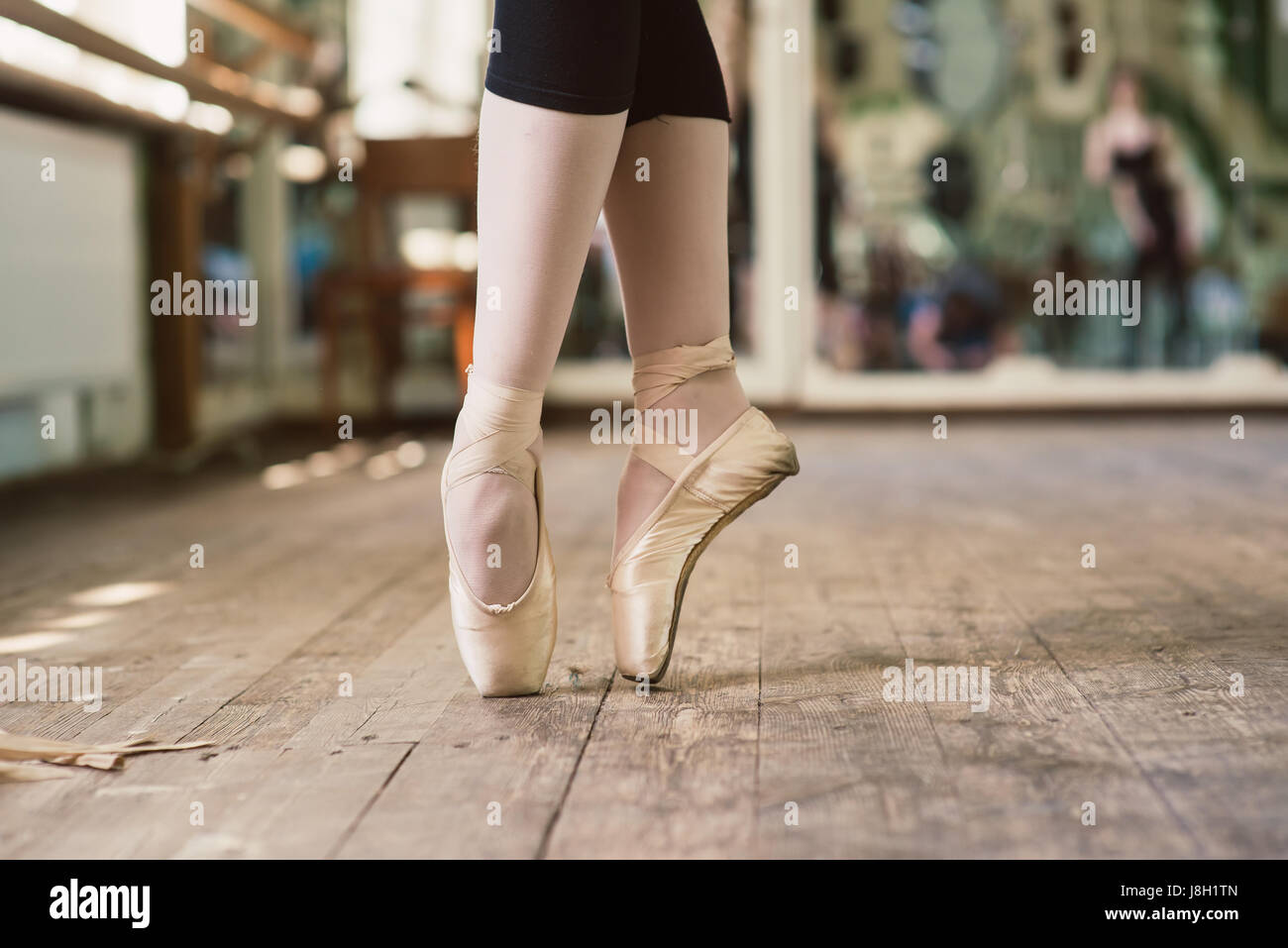 Feet of ballerina dancing in ballet shoes. Ballerina standing on toes ...
