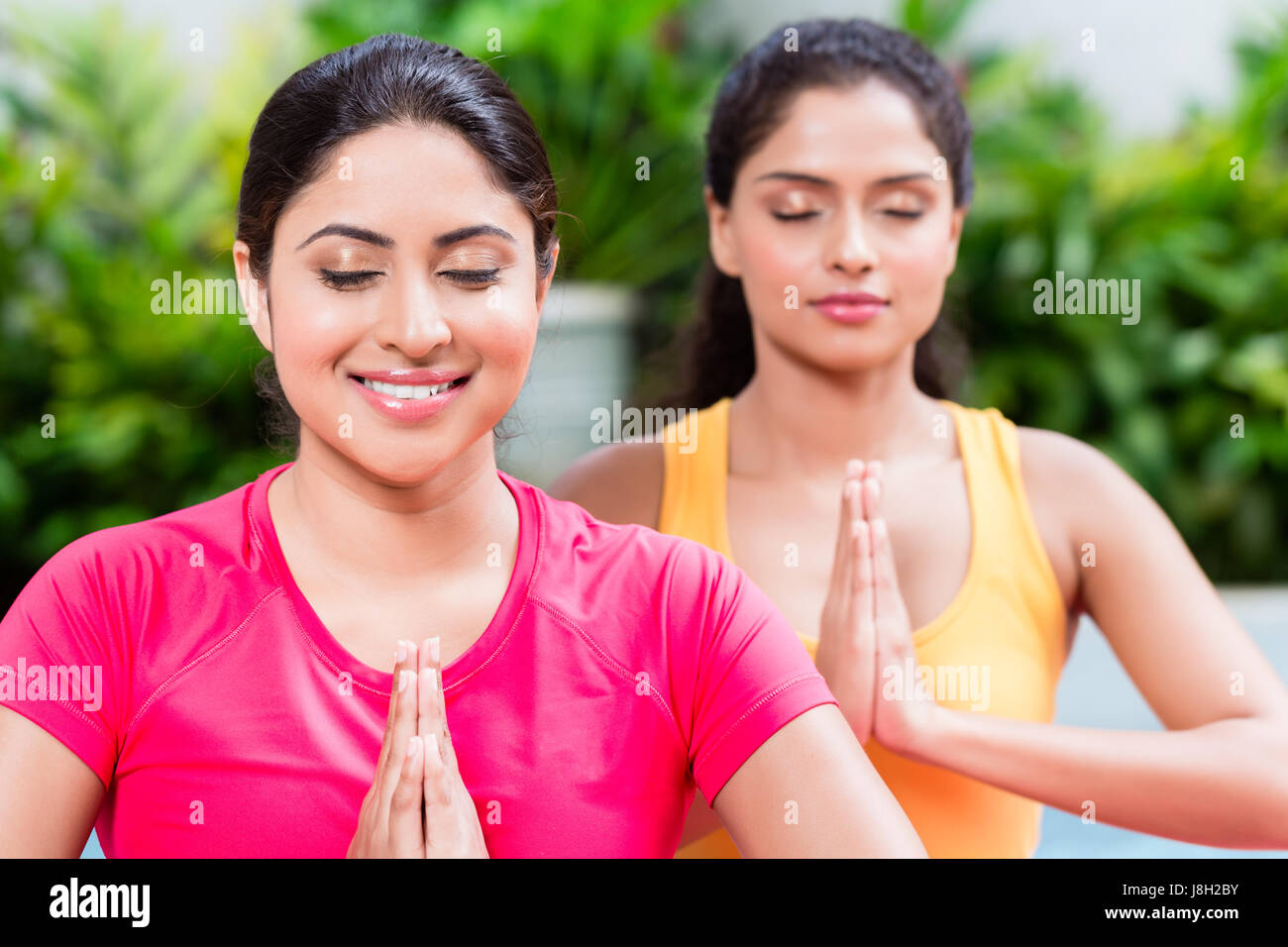 Two women in lotus position during yoga practice Stock Photo - Alamy