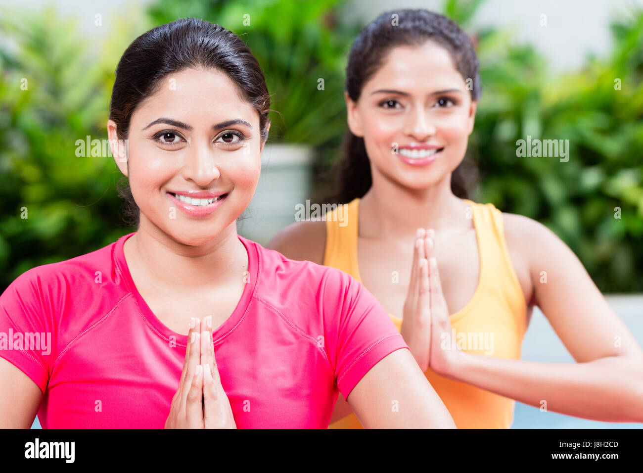 Two women in lotus position during yoga practice Stock Photo - Alamy