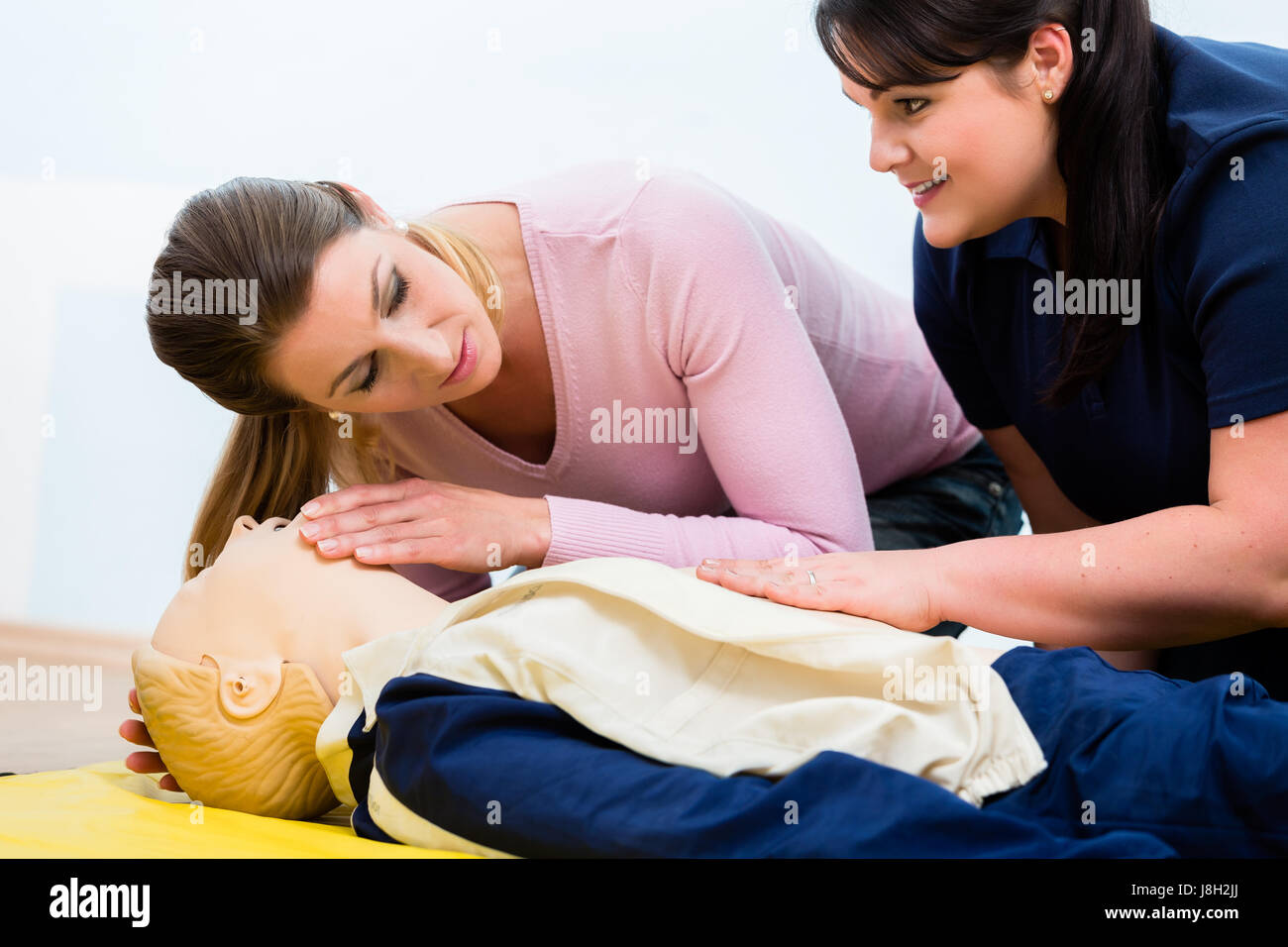 Group of women in first aid class exercising reanimation Stock Photo ...