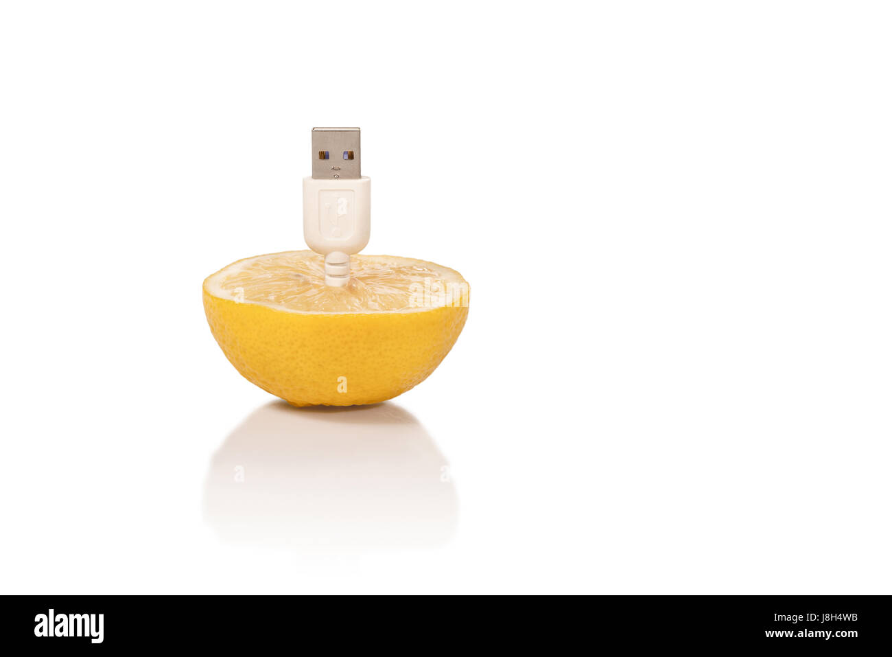 Conceptual picture - half yellow lemon with a usb plug stuck out of it ...