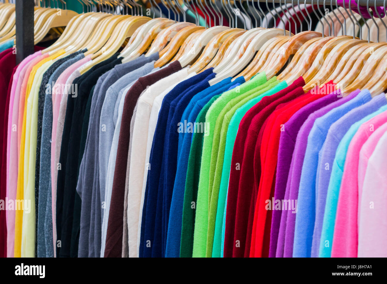 shirt color Variety of clothes hanging on rack in boutique Stock Photo ...