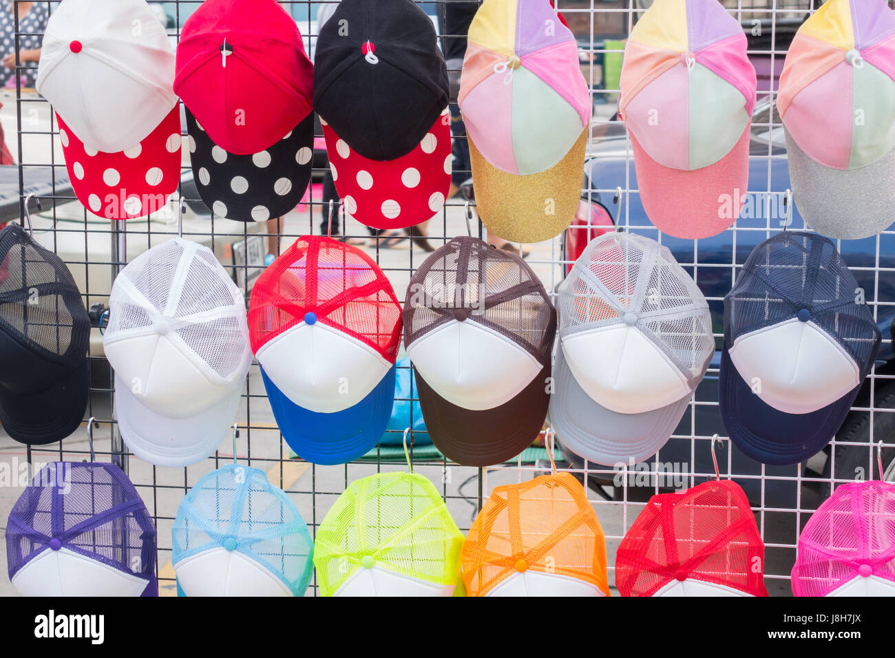 cap, hat Variety of hanging on rack in boutique Stock Photo - Alamy