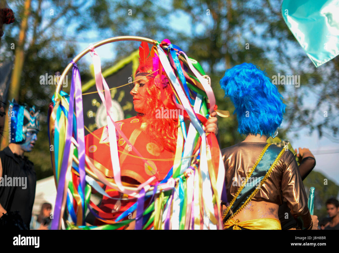 A performer carries a hula hoop with colored ribbons during a galactic ...