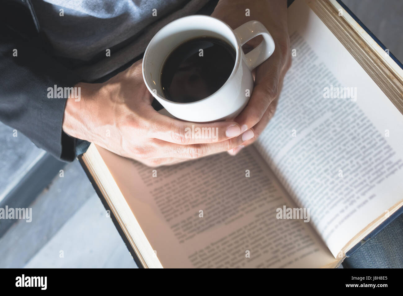Read a book, enjoy a quiet coffee Stock Photo - Alamy