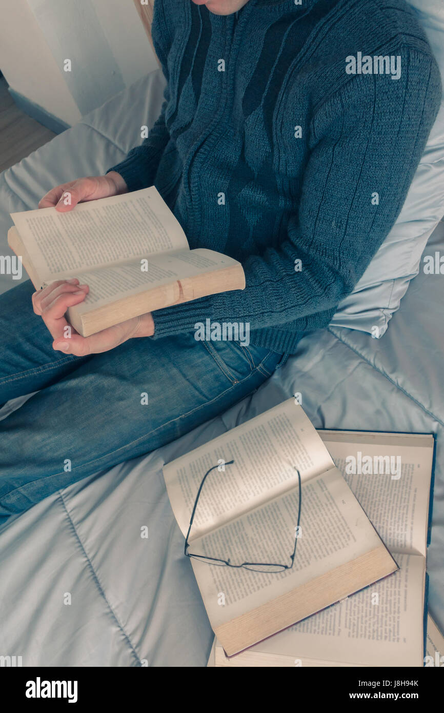 Enjoy reading a book in bed Stock Photo - Alamy