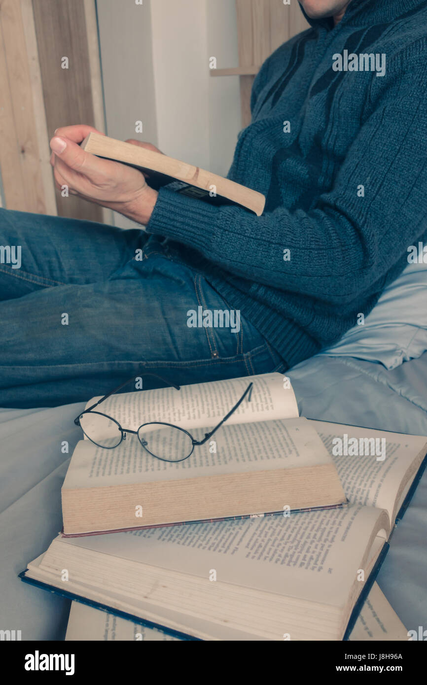 Enjoy reading a book in bed Stock Photo - Alamy