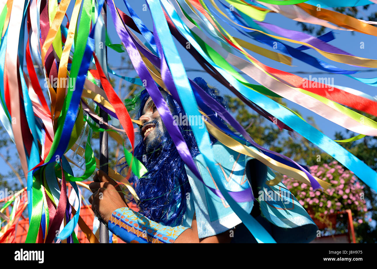 A performer walks through colored ribbons during a galactic parade at ...