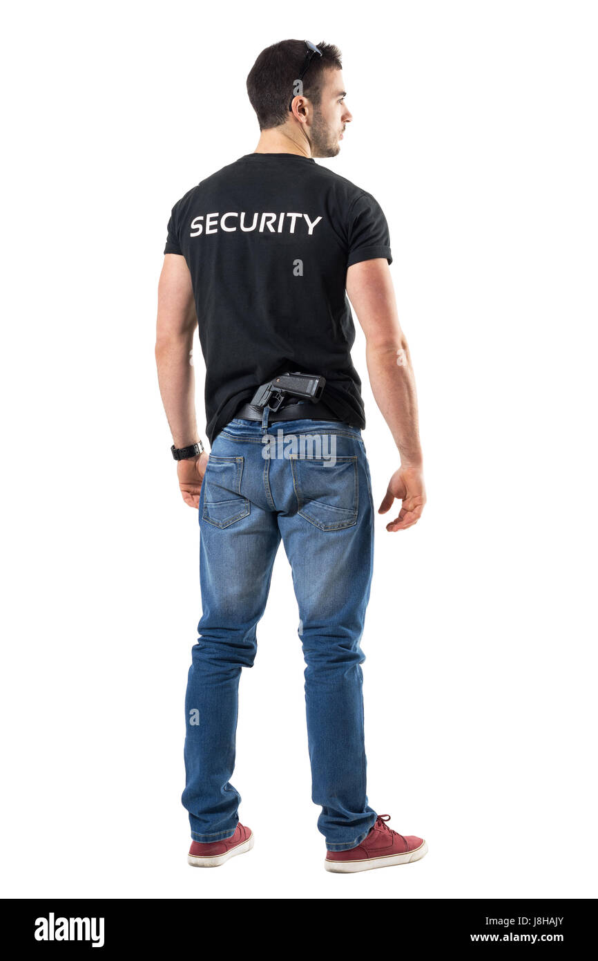 Rear view of undercover policeman with gun attached on his back belt ...