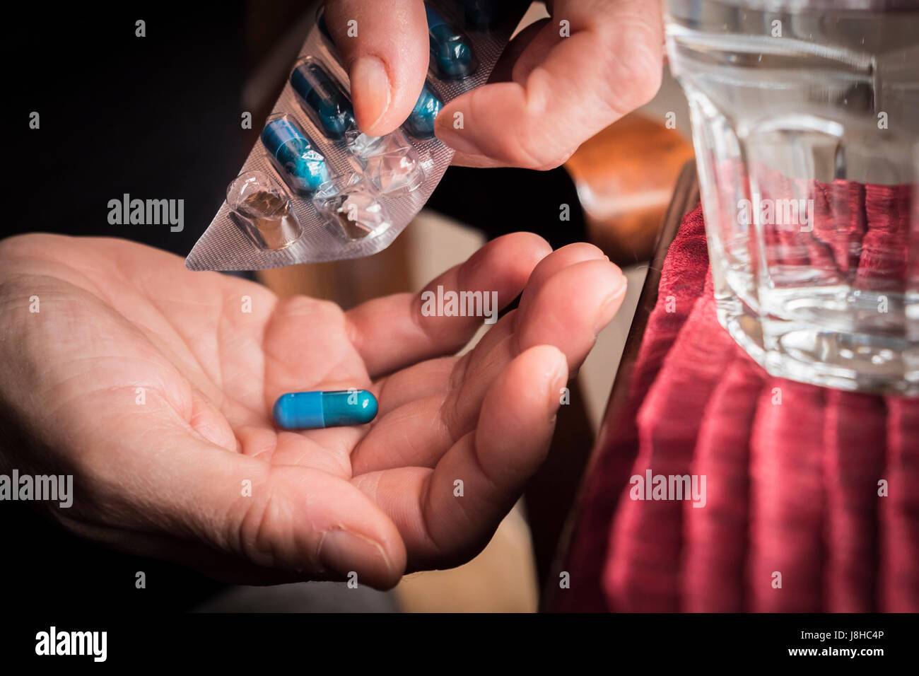 Women take blue capsule with left hand from a container pills Stock ...