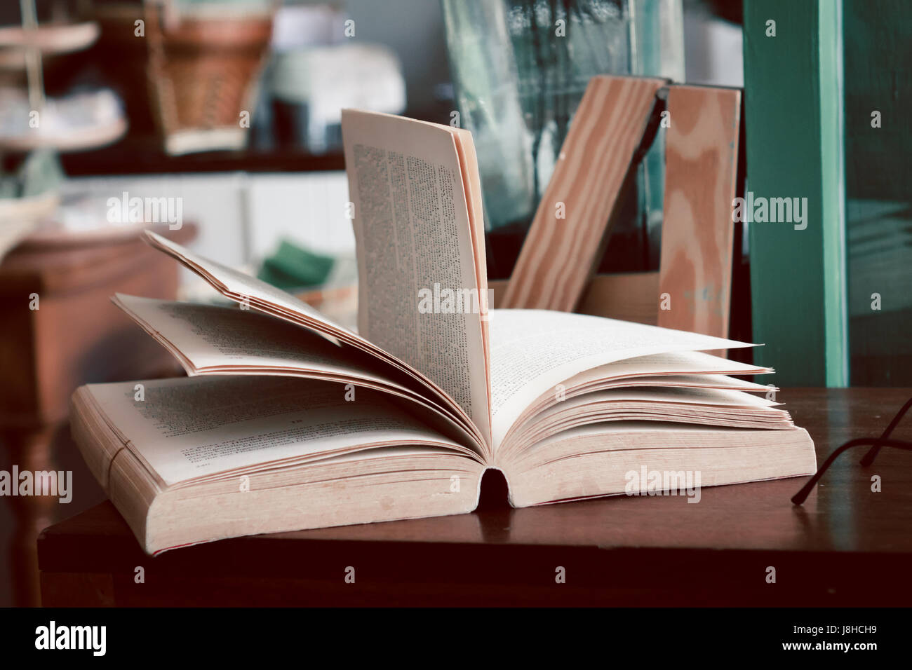 Open book left on the table Stock Photo - Alamy