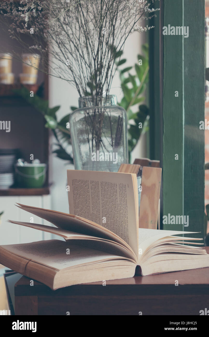 Open book left on the table Stock Photo - Alamy