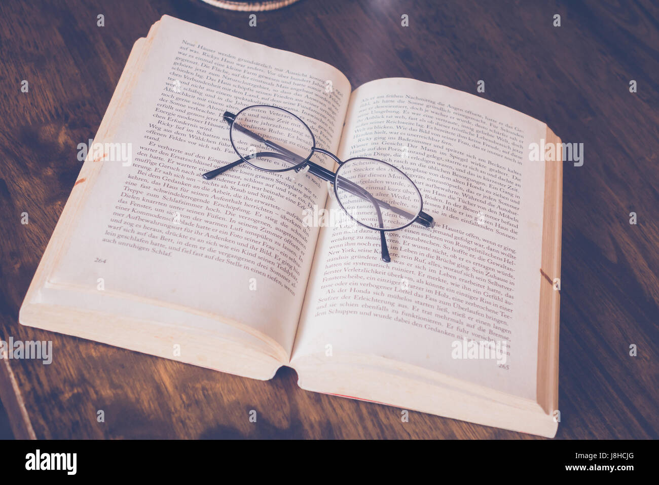 Open book left on the table Stock Photo - Alamy