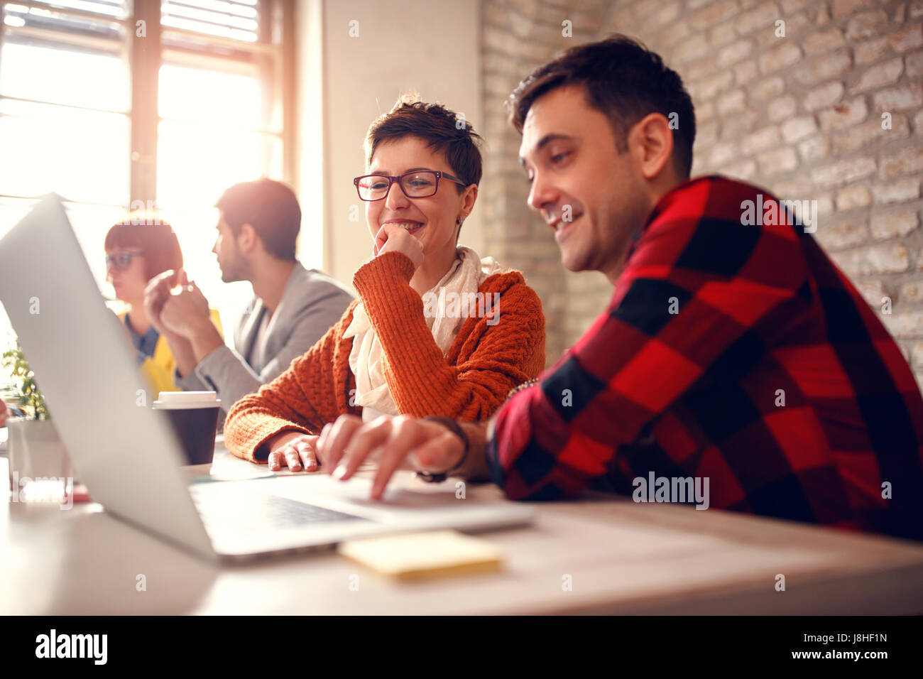 Working on design- designers in good mood working together Stock Photo ...