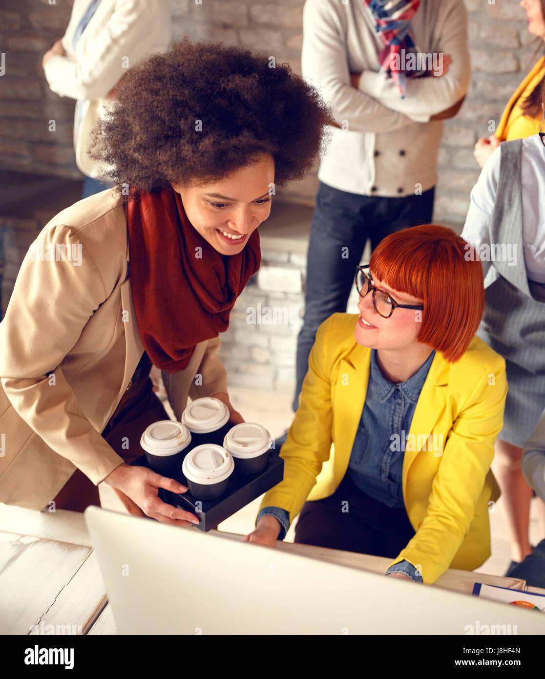 Working group looking with interested something on computers screen in ...