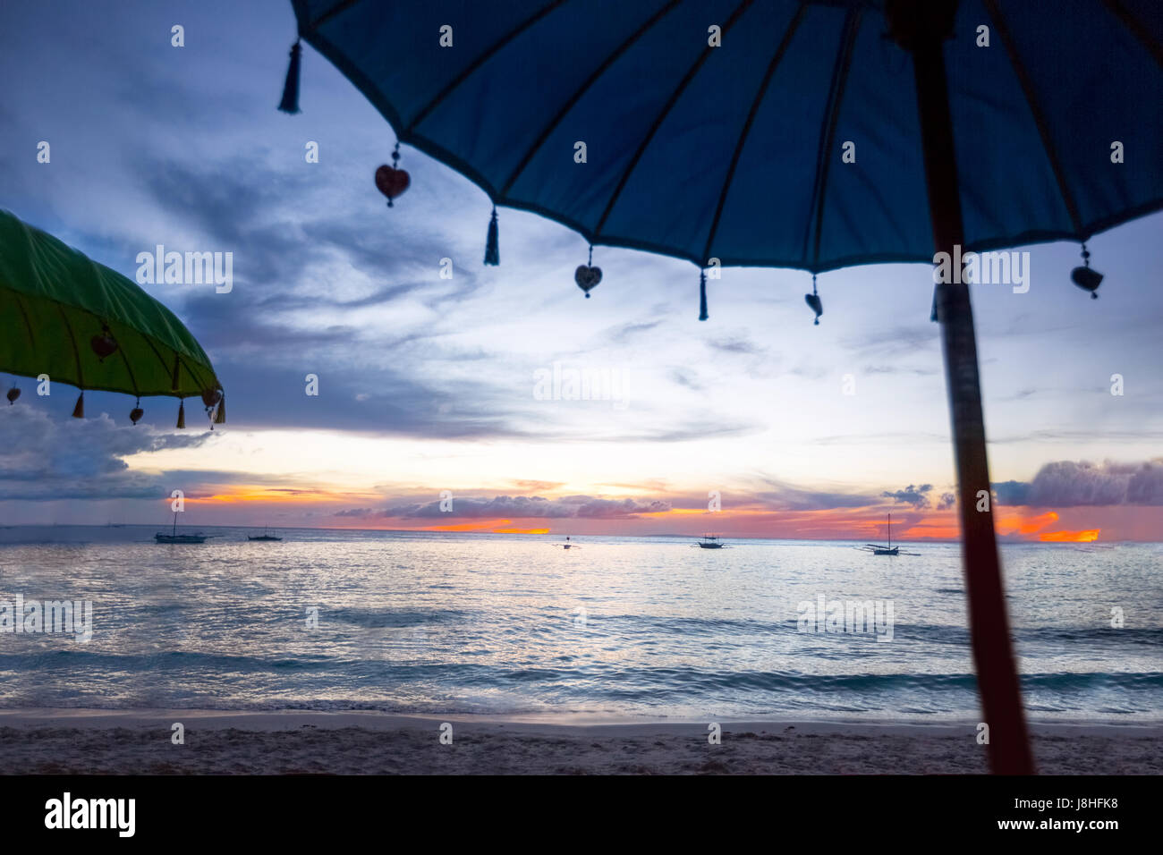 sunshade on the Bali beach sunset Stock Photo - Alamy