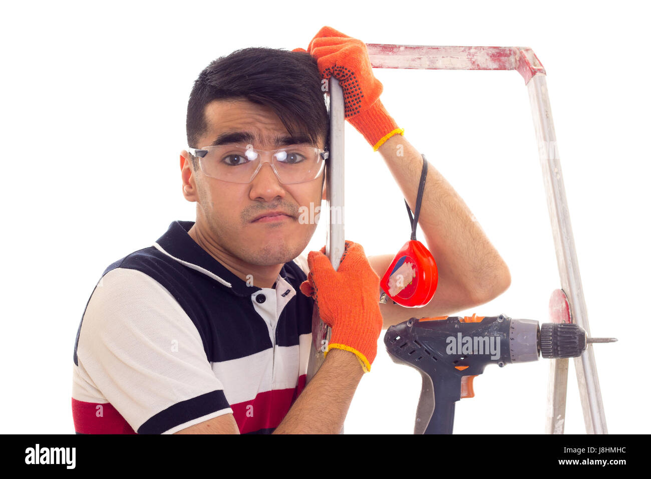 Disturbed young man with black hair in white and blue t-shirt and jeans ...