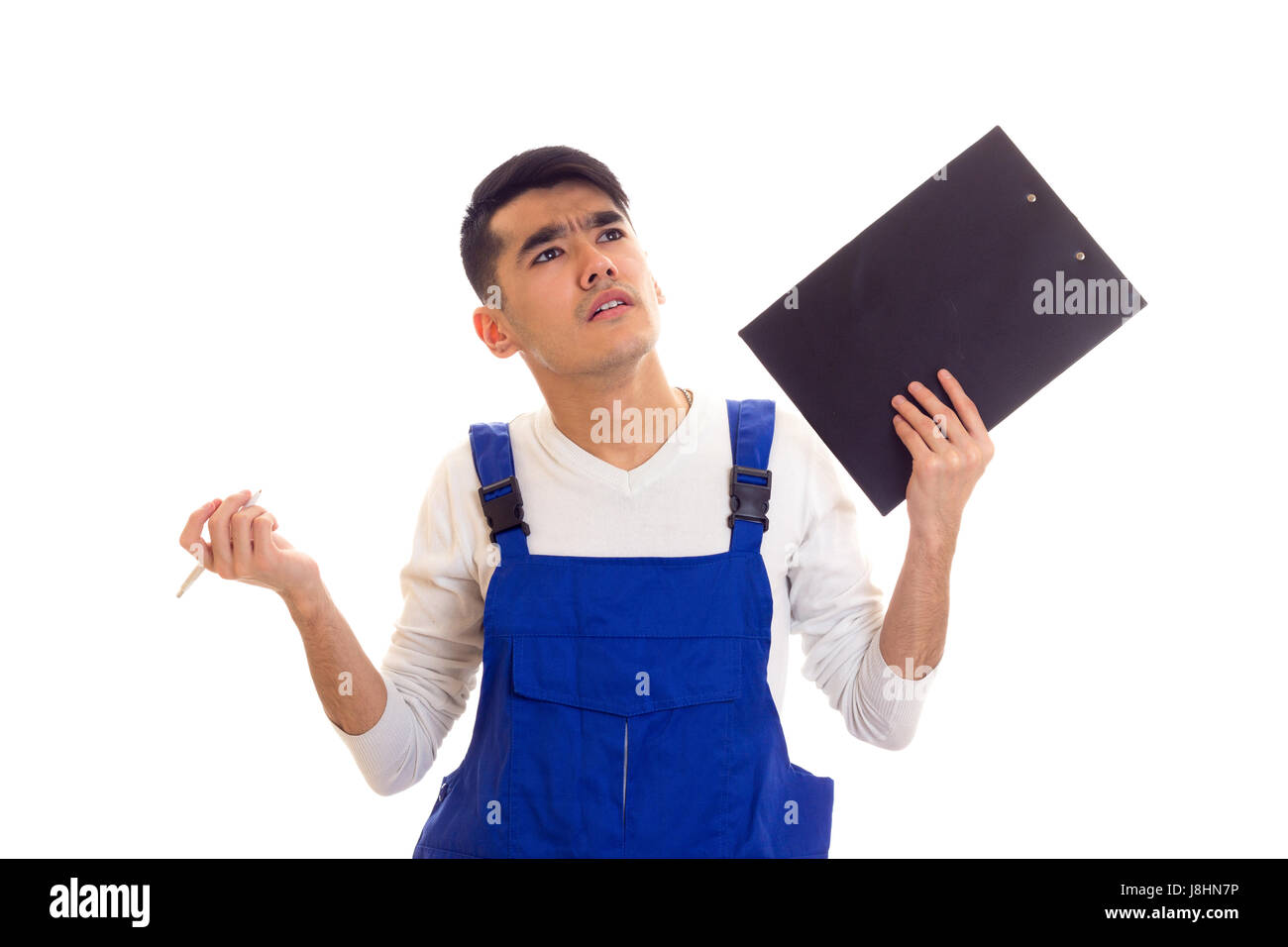 Young disturbed man with dark hair wearing in white shirt and blue ...