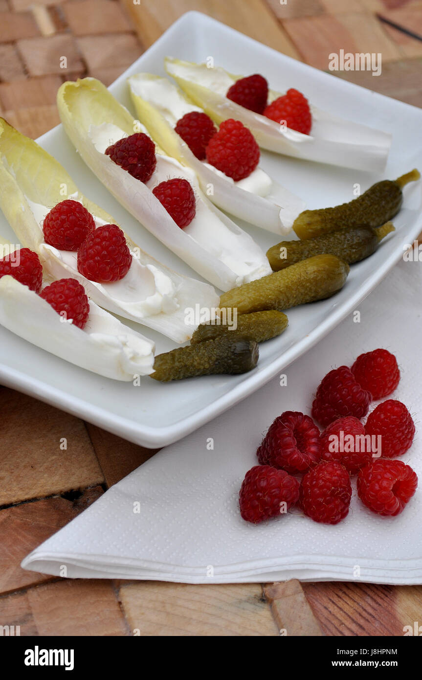 Endives on tray, cheese and raspberries Stock Photo - Alamy