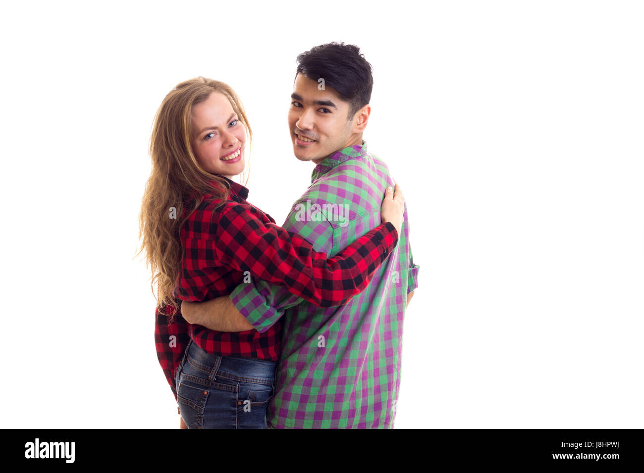 Young couple in plaid shirts hugging Stock Photo - Alamy