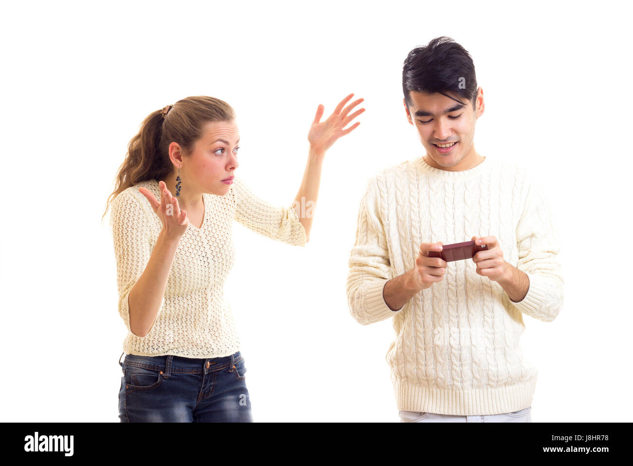 Man using smartphone and woman arguing Stock Photo - Alamy